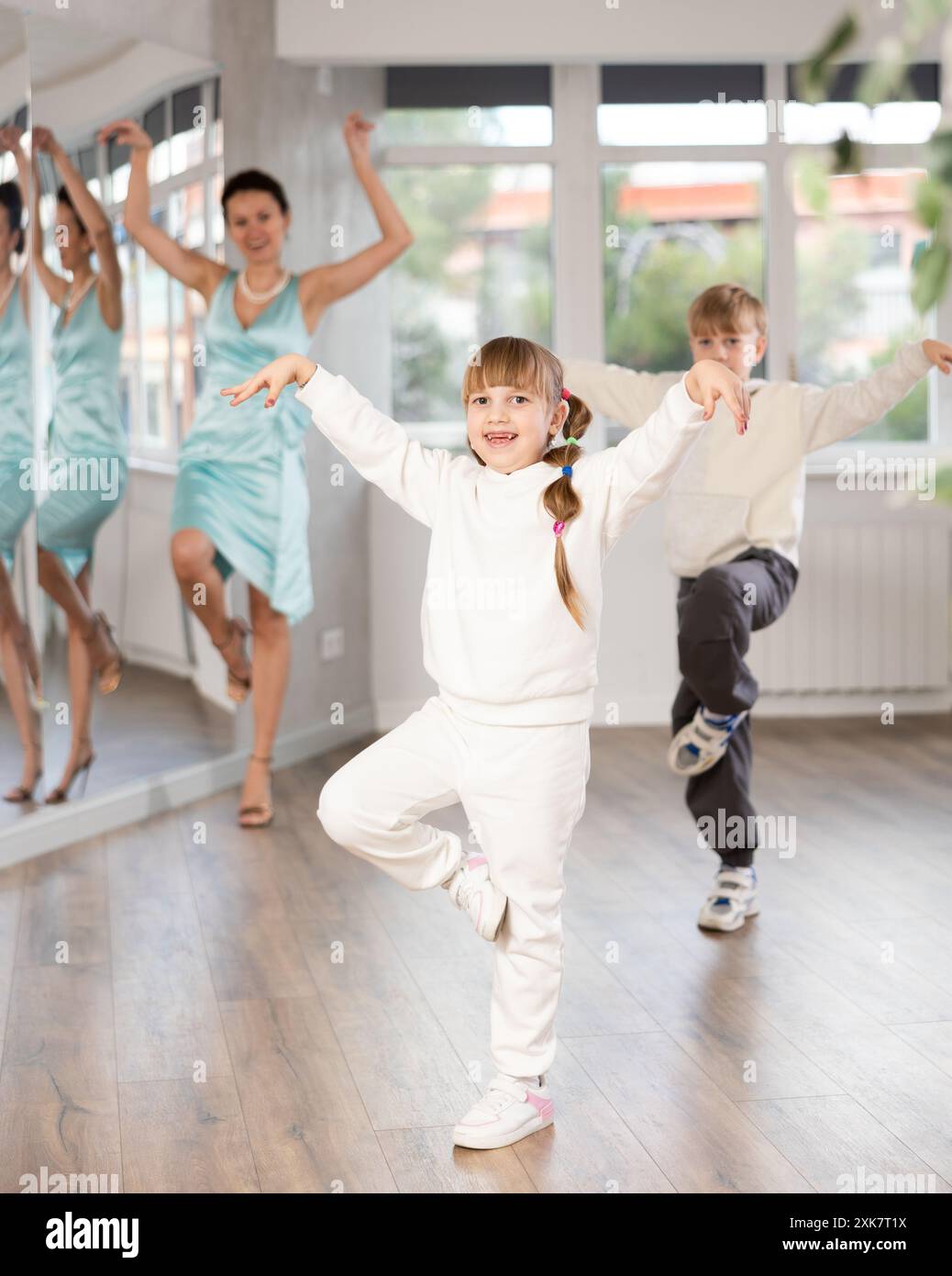 Tween girl and boy learning modern street dancing in choreographic ...