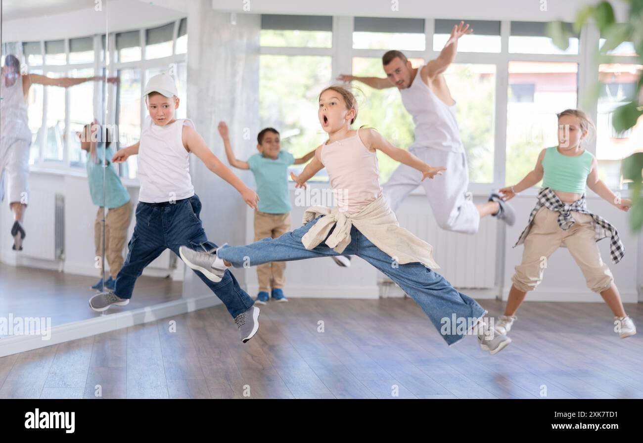 Preteen girl in mid-jump during hip hop dance class Stock Photo - Alamy