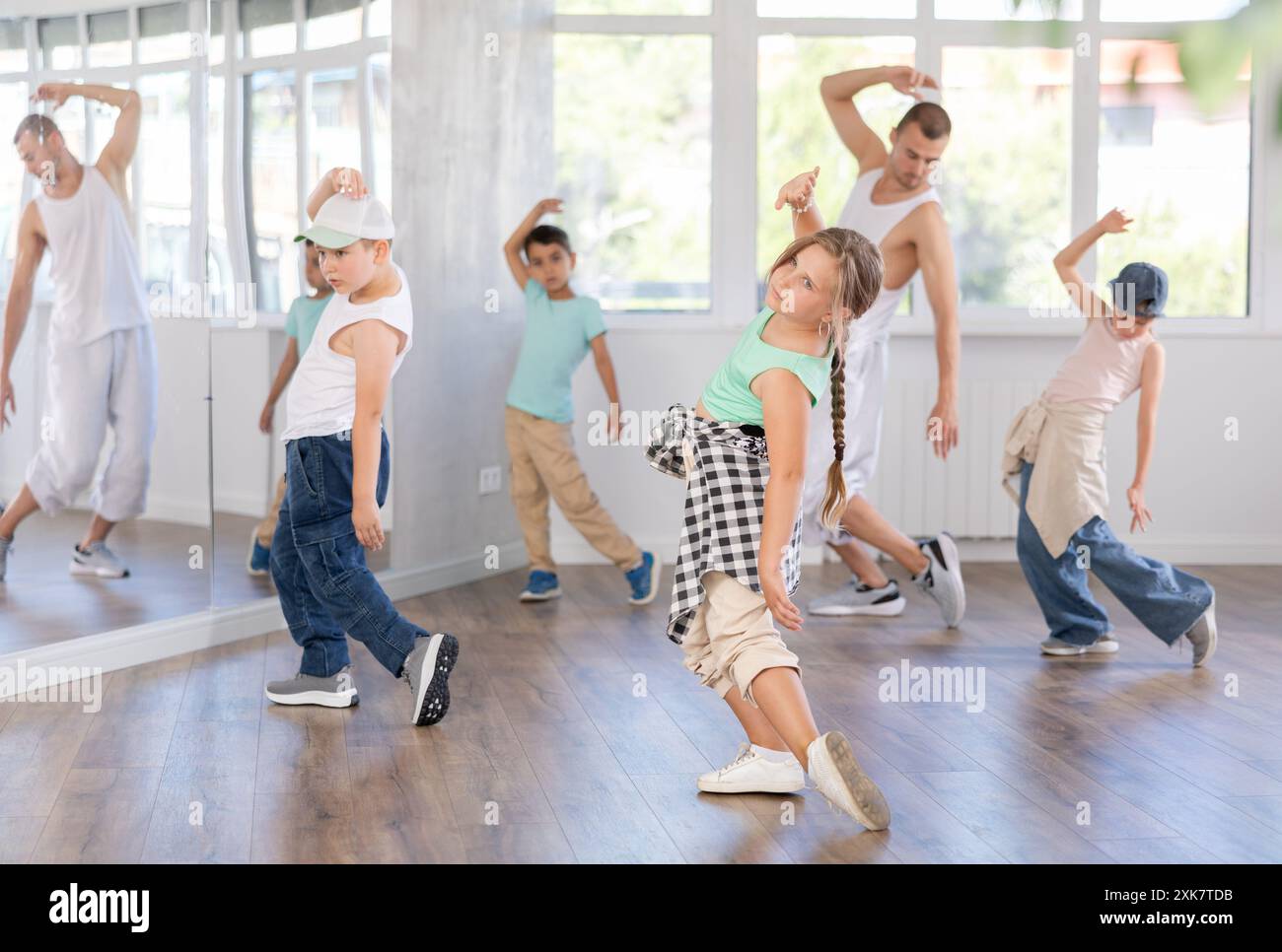 Children, together with dance teacher, practice hip-hop and ...
