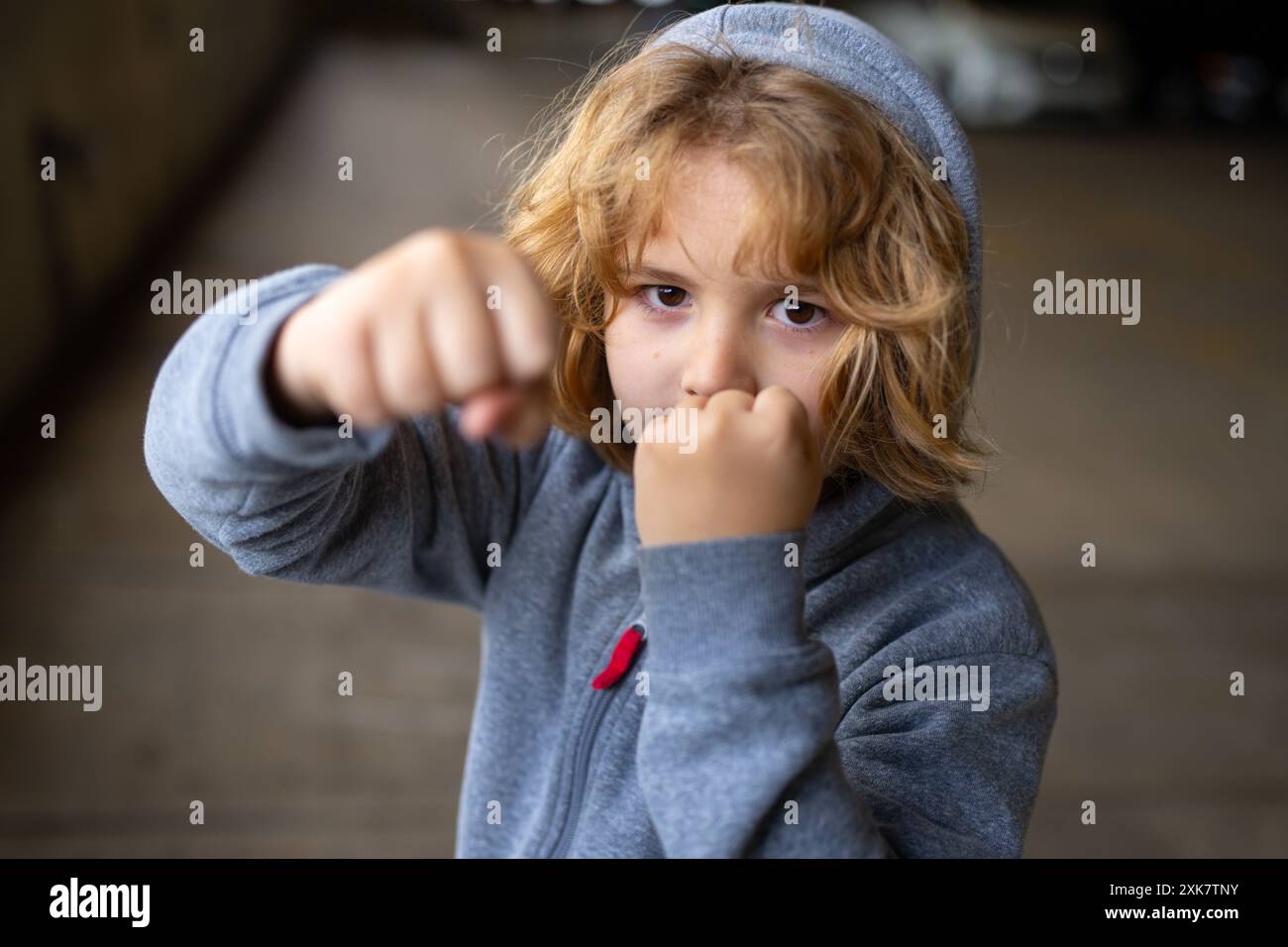 Kid boy in hoodie fighting. Little kid boy fighting outside. Angry ...
