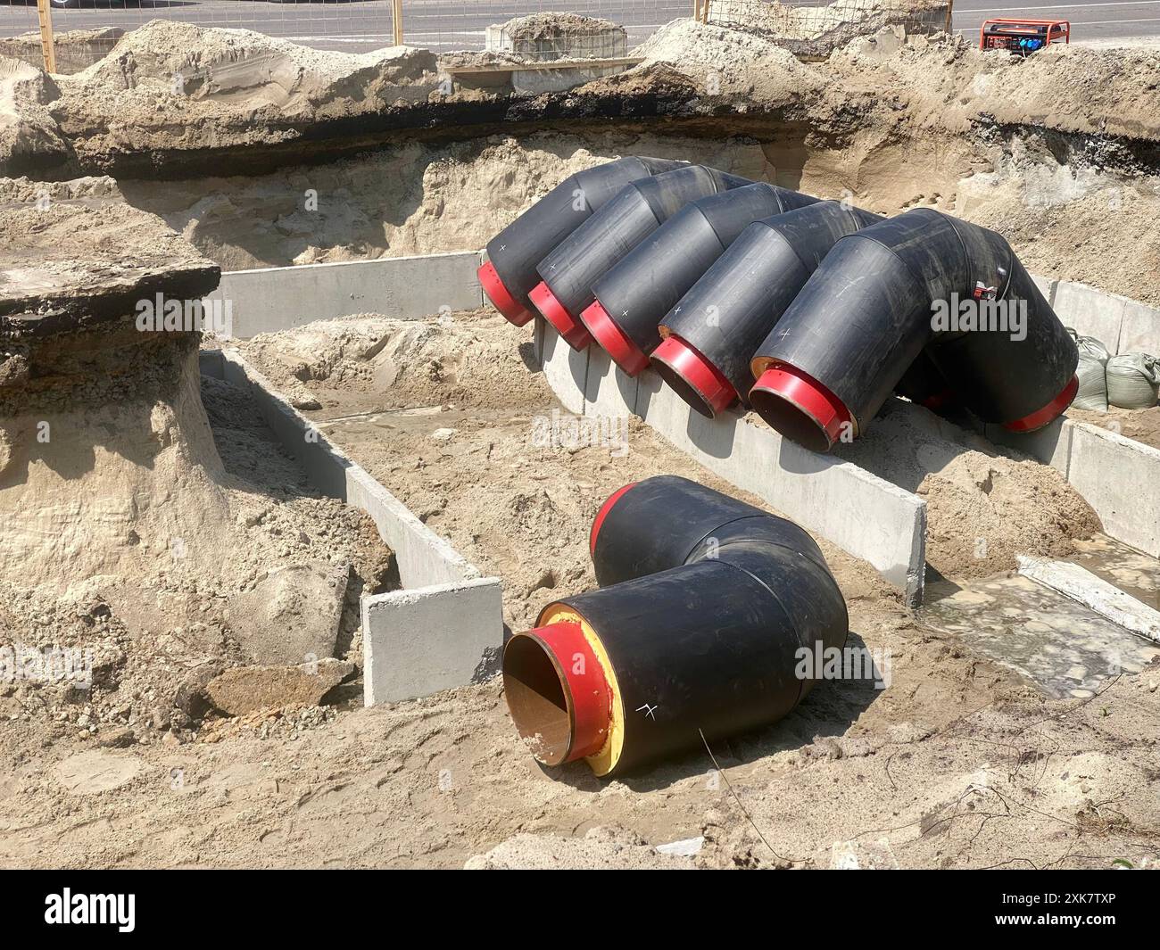Construction industry. Builders are laying heat supply pipes to a new ...