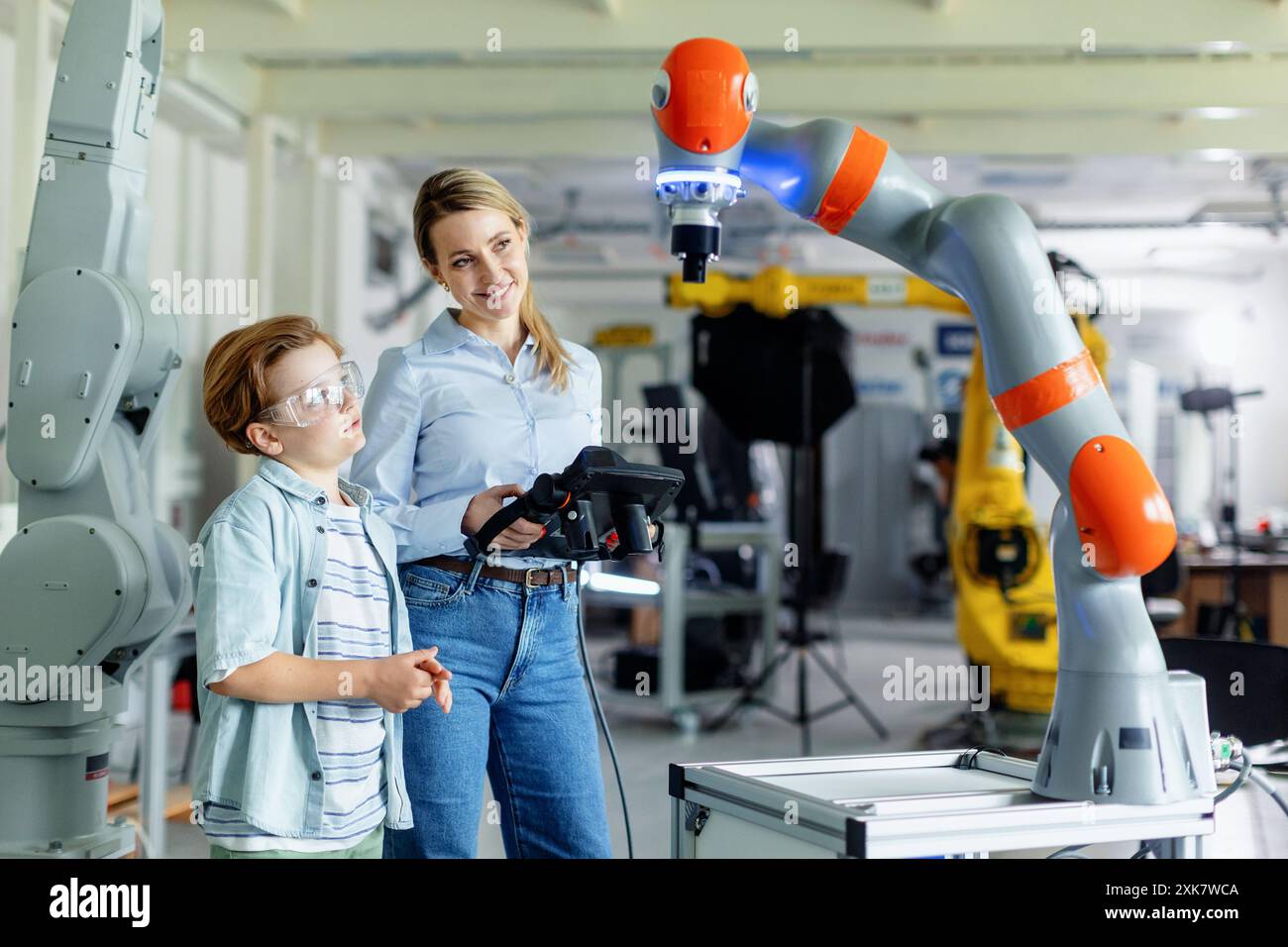 Mom and boy during take your kid to work day, encouraging children in ...