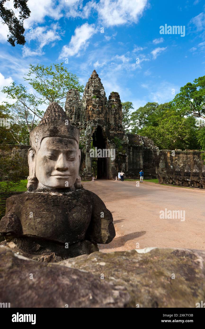 Stone sculptures border the bridge to the temple Angkor Thom in Angkor ...