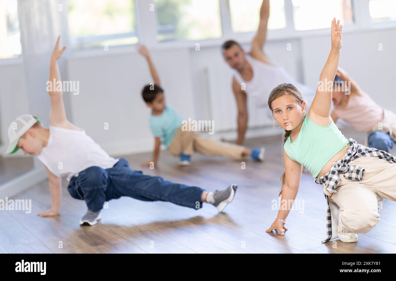 Cheerful sports preteen girls and boys hip hop dancers doing dance ...