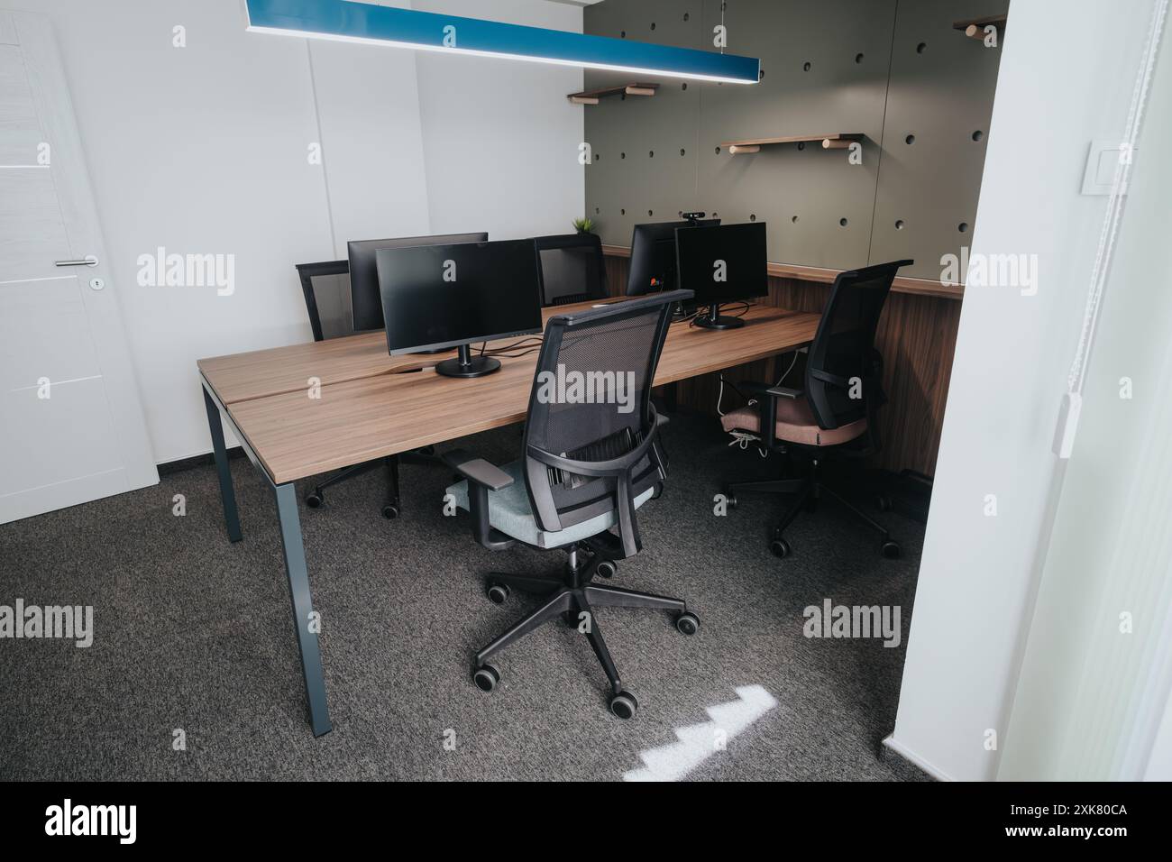 Modern office space with ergonomic chairs and sleek desktop setups ... Modern office space with ergonomic chairs and sleek desktop setups ...