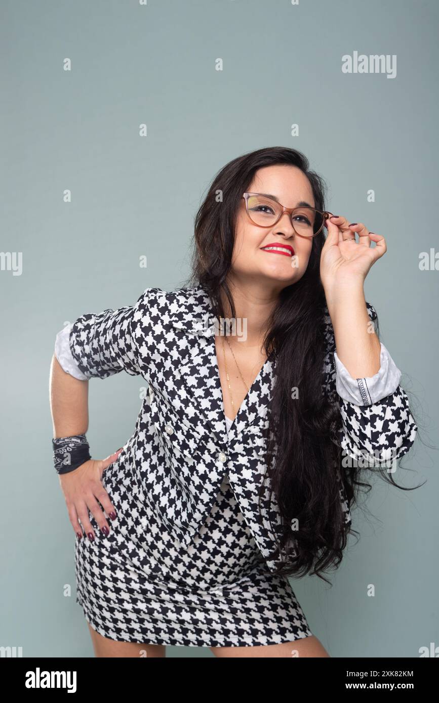 Beautiful smiling woman with long black hair, leaning forward, wearing ...