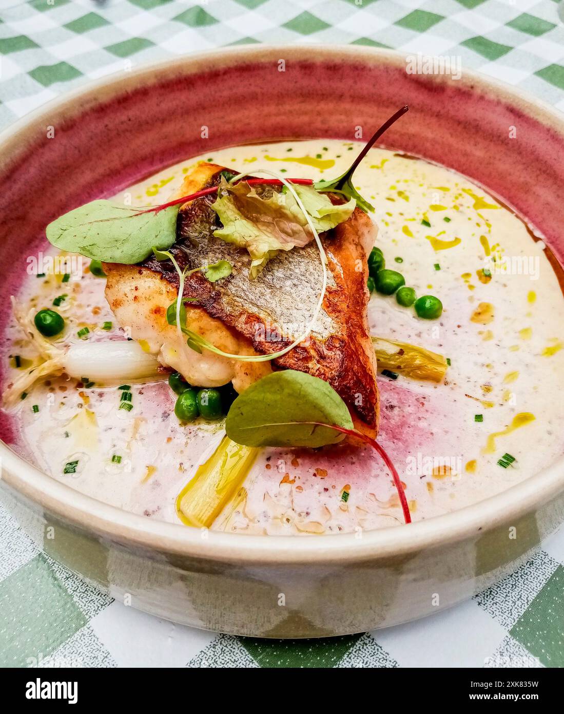 Top view of Irish cod fish fillet dish with peas and white sauce Stock ...