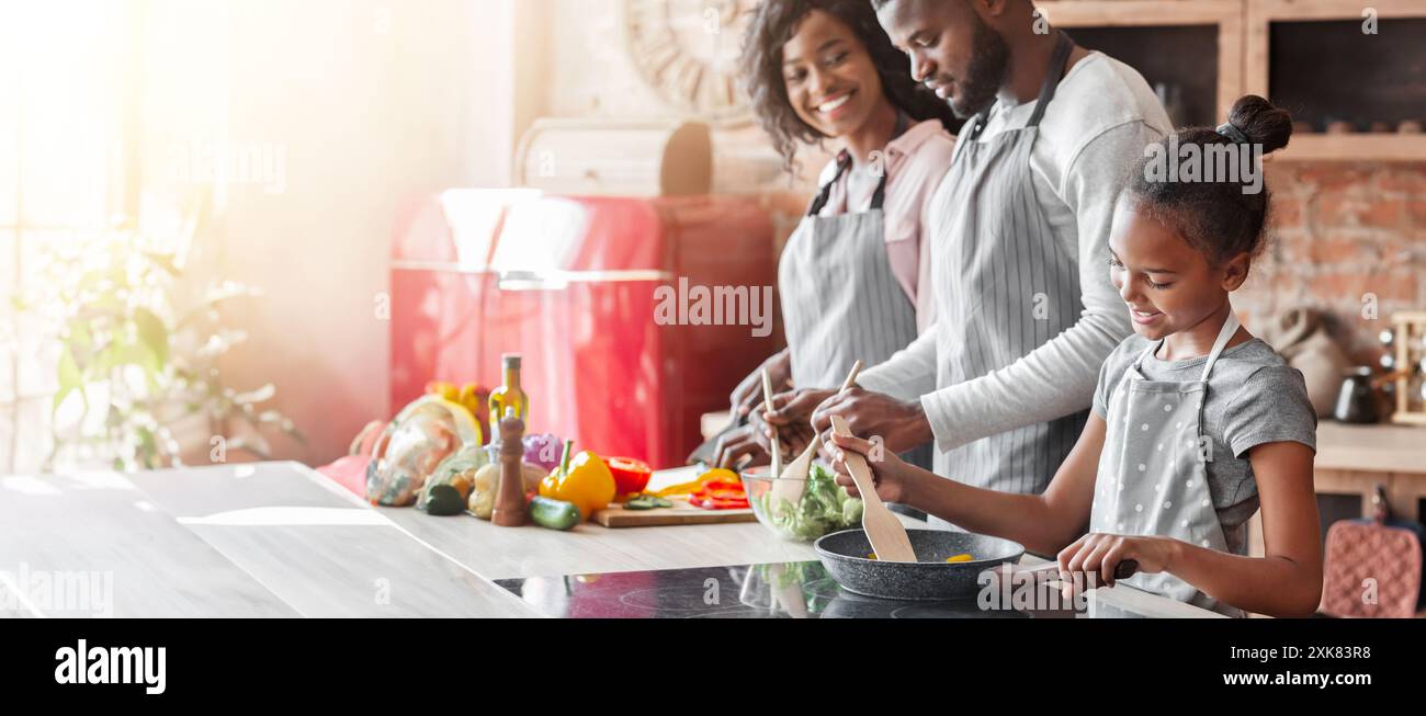 Child making dinner african american hi-res stock photography and ...