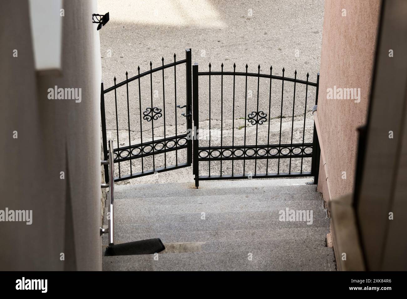Grey steps in city and old metal gate. Detail of old staircase ...