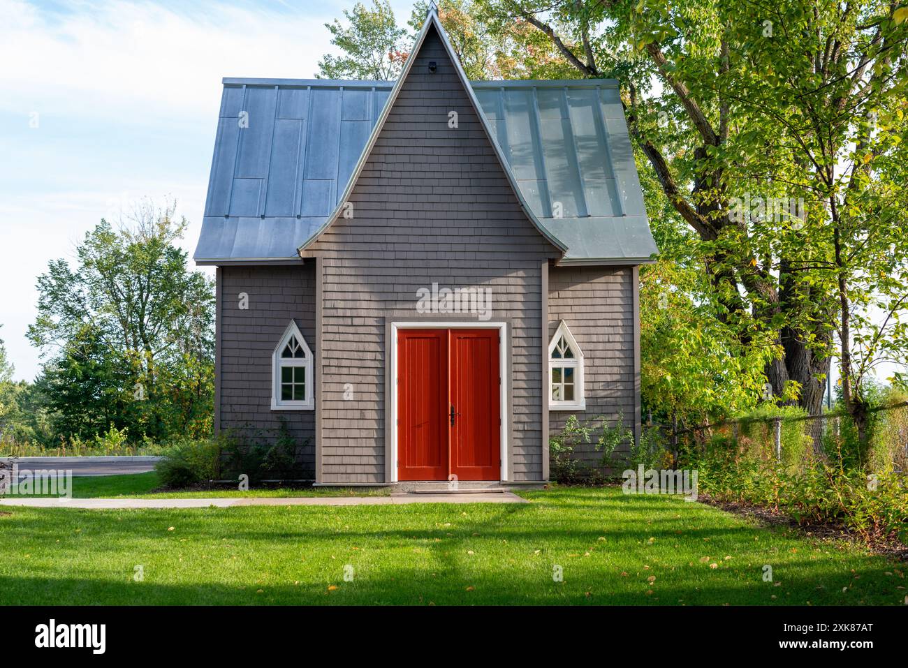A small or tiny house with grey exterior wooden walls, small clear ...