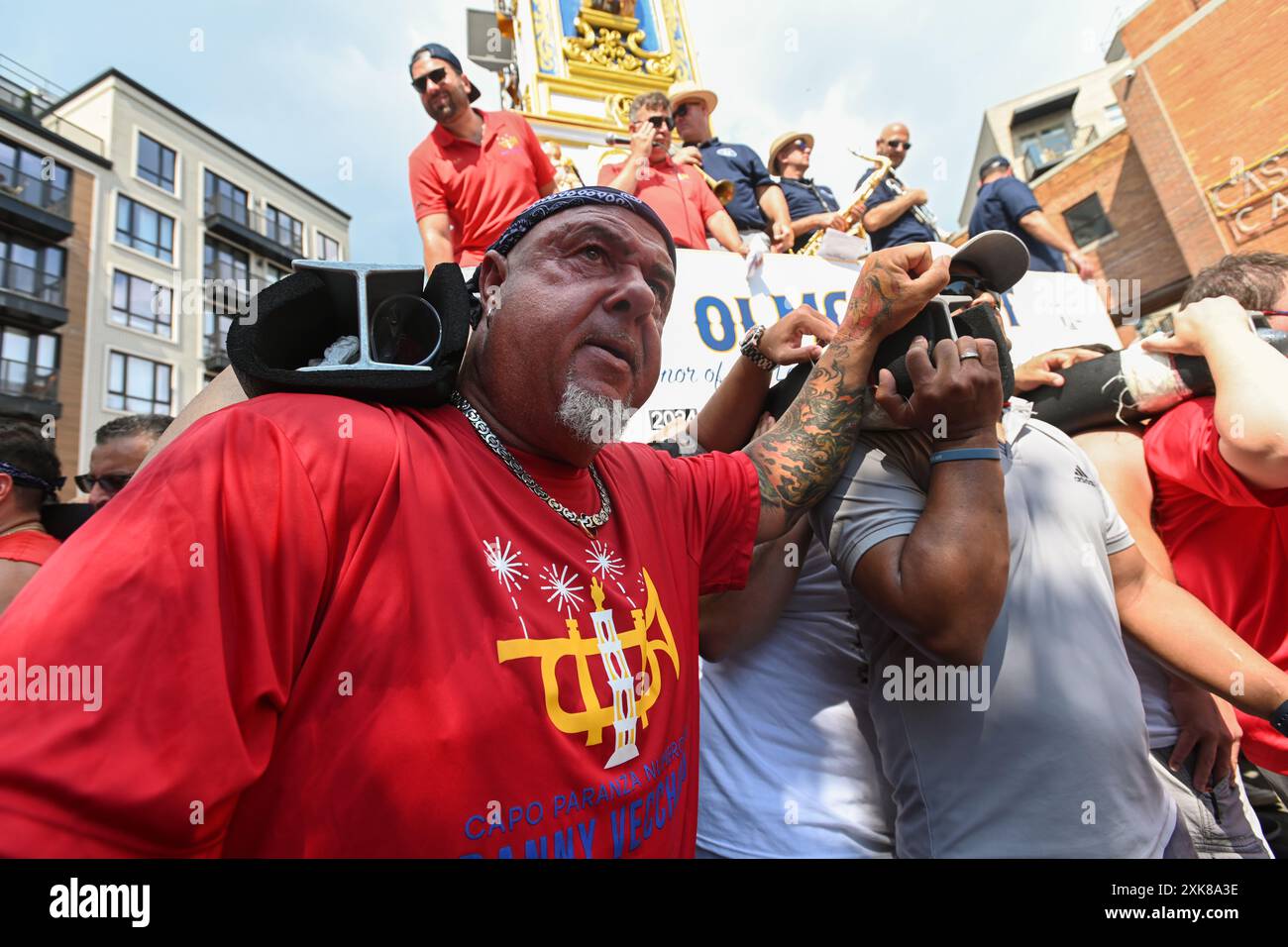 Lifters carry the 80-foot tall, 4-ton Giglio tower near the Shrine ...