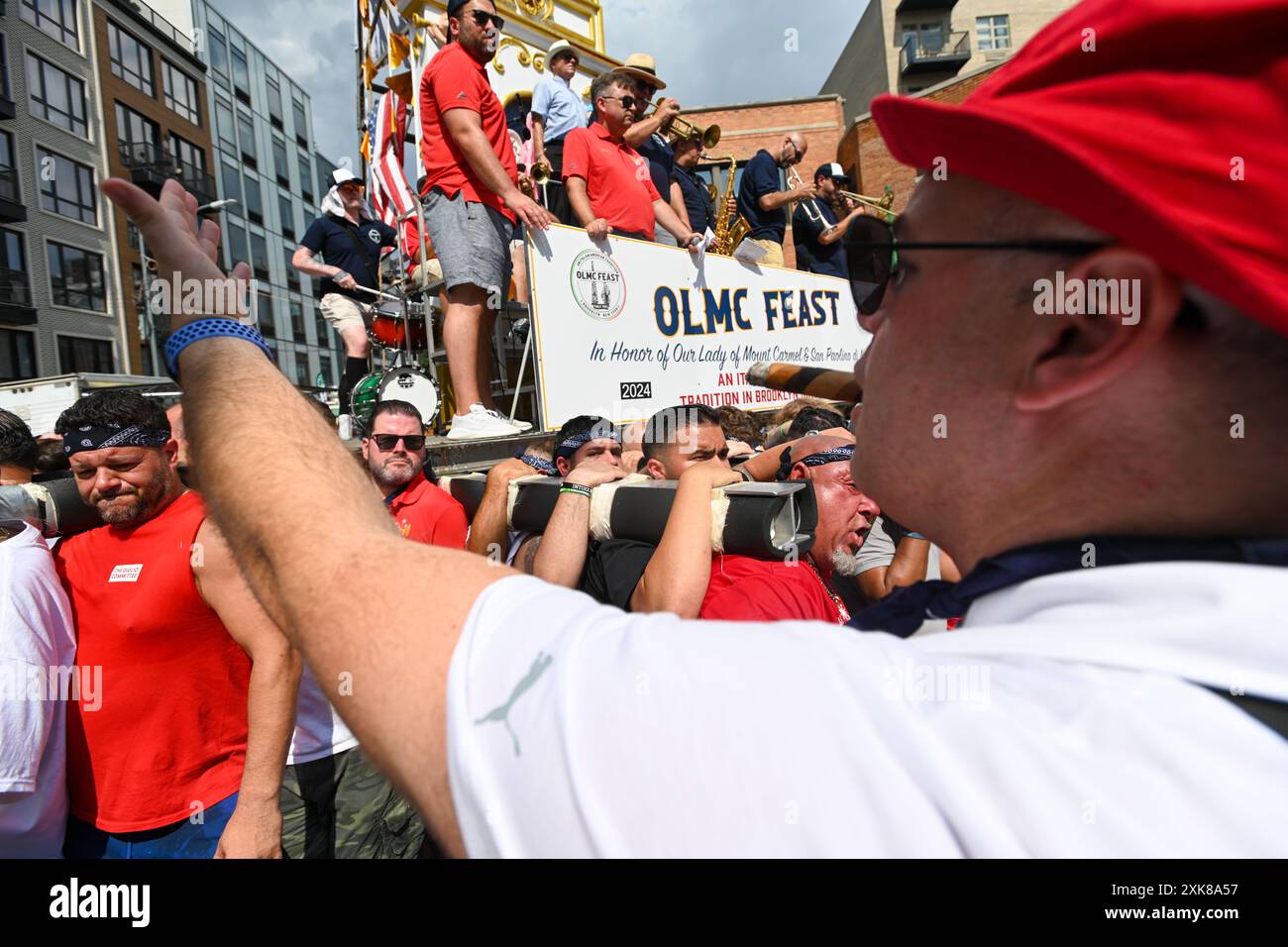 Lifters carry the 80-foot tall, 4-ton Giglio tower near the Shrine ...