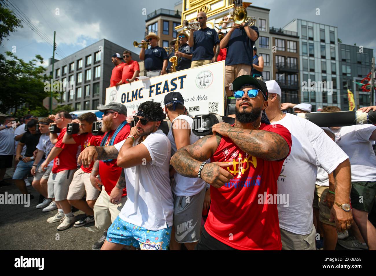 Lifters carry the 80-foot tall, 4-ton Giglio tower near the Shrine ...