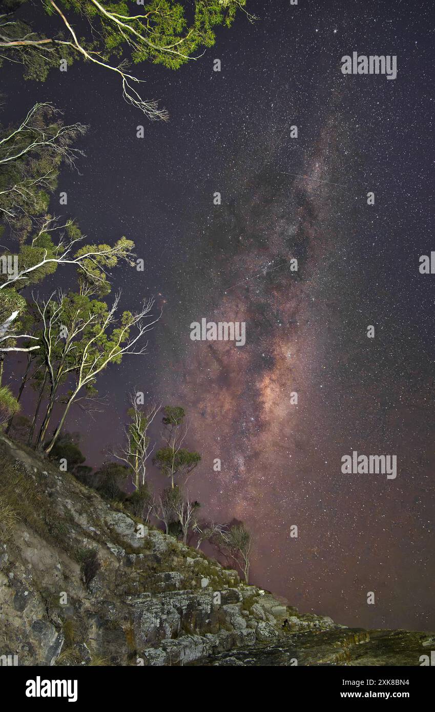 Galactic bulge of Milky Way stars at night with light painting of cliff ...
