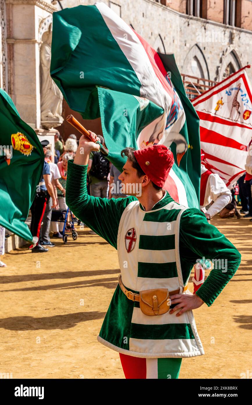 A Young Man From The Oca (Goose) Contrada Flag Waving In The Piazza Del ...