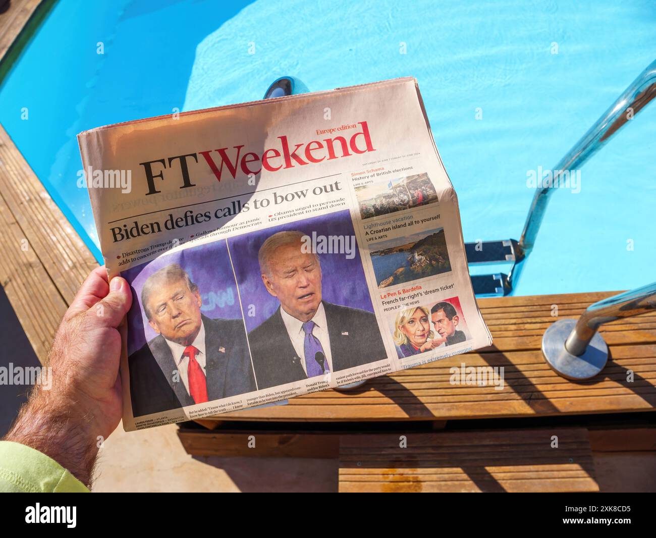 Palma, Spain - Jul 10, 2024: Near a pool with clear blue water, a male ...