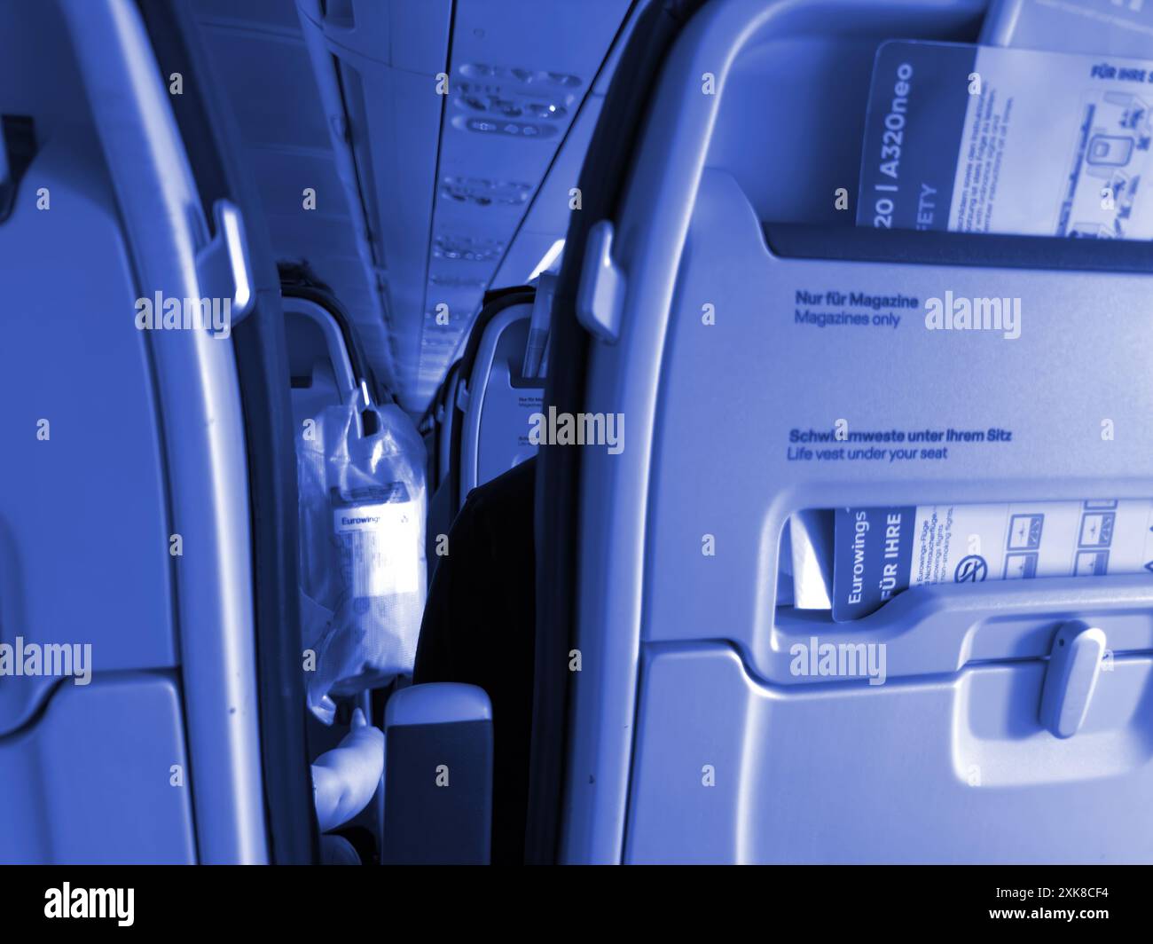 Germany - Jul 11, 2024: View through airplane seats shows a long ...