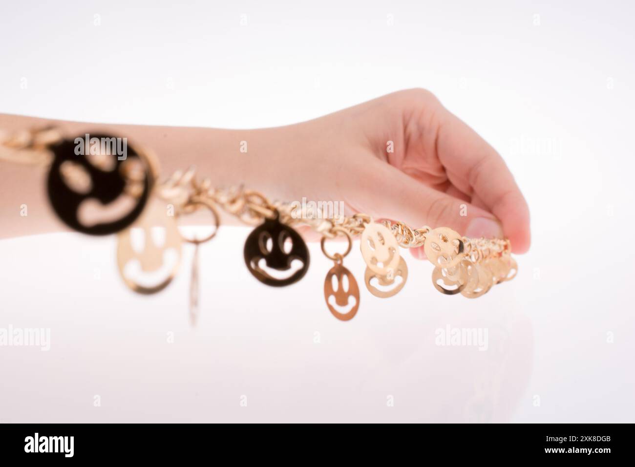 Golden color smileys arrayed on a chain in hand Stock Photo - Alamy