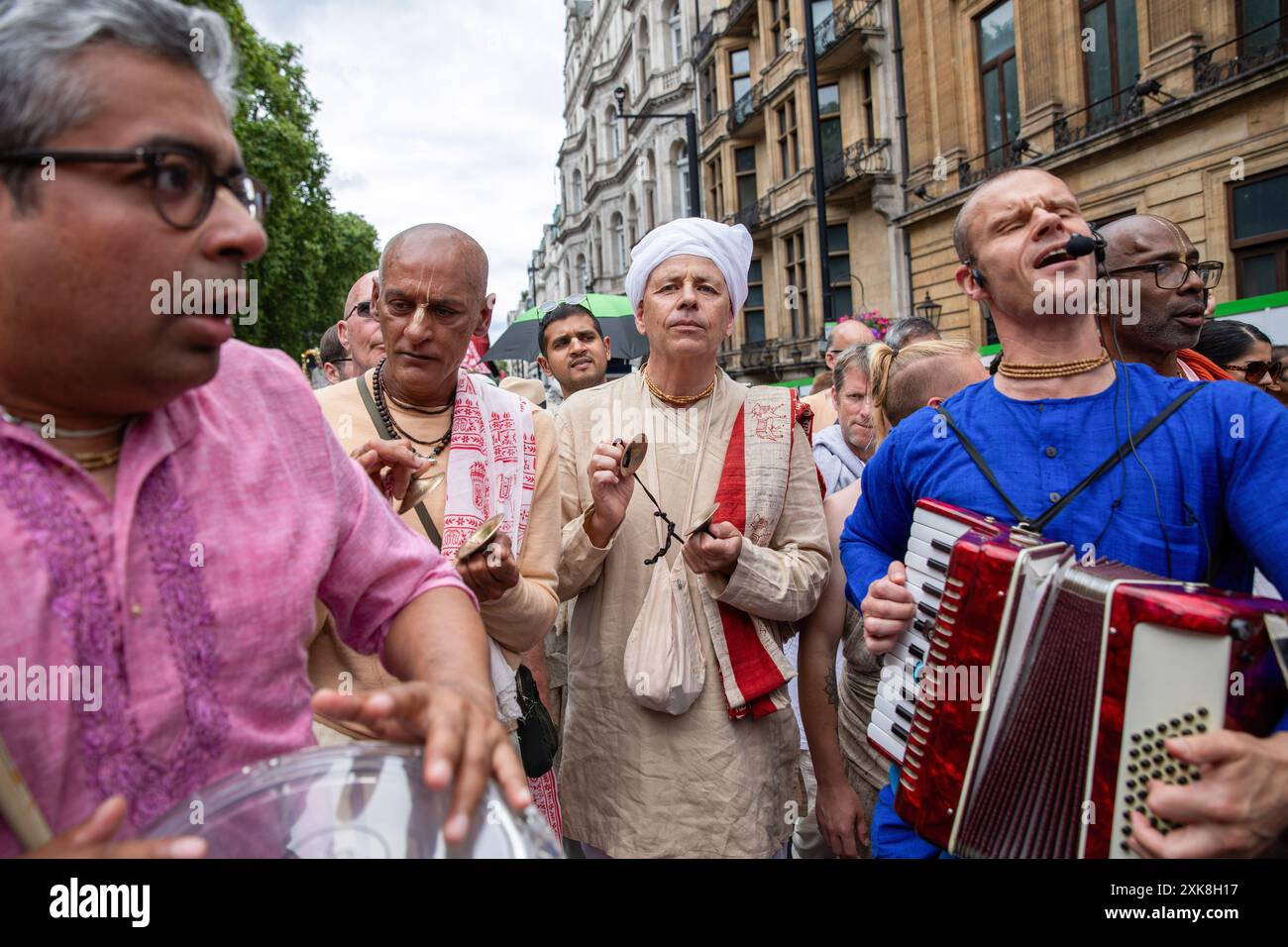 Hare Krishna followers sing whilst playing traditional Indian ...