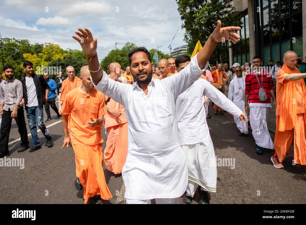 A male Hare Krishan devotee dances with his hands in the air. Thousands ...