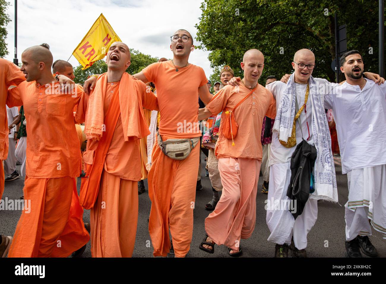 Male Hare Krishna devotees dance in a line. Thousands of followers of the Hare Krishna religion ...