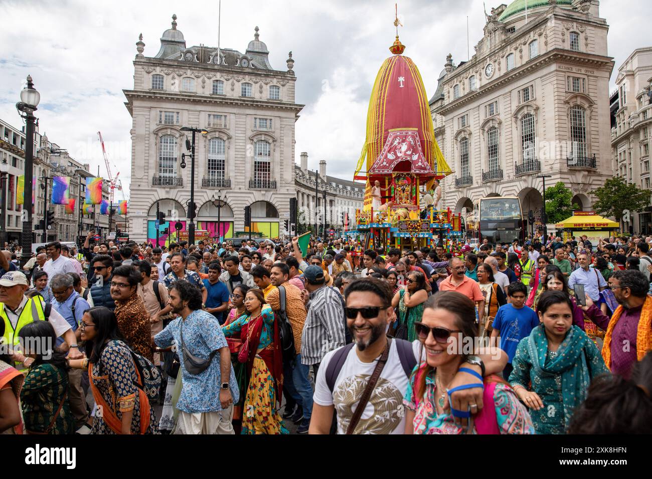 A Hare Krishan Chariot is Pulled through crowds on a busy street ...