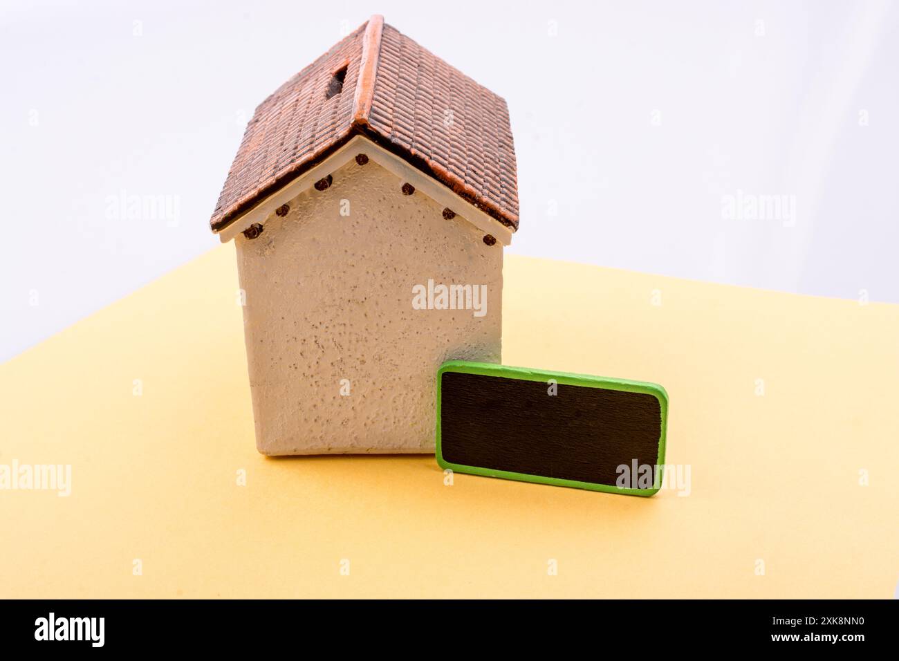 Little model house with a sign board in the view Stock Photo - Alamy