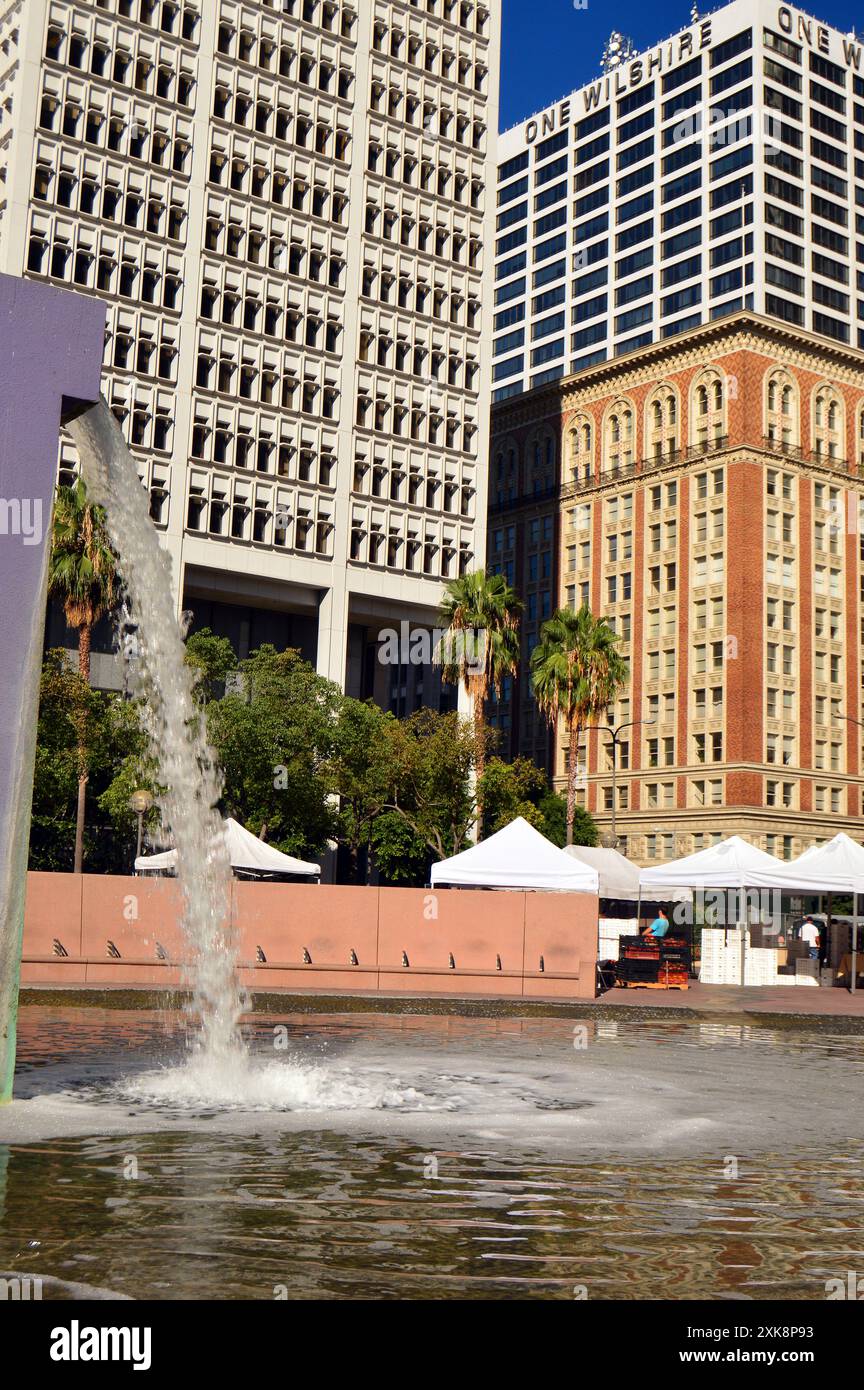A purple fountain gushes in Pershing Square, surrounded by the skyscrapers of downtown Los ...