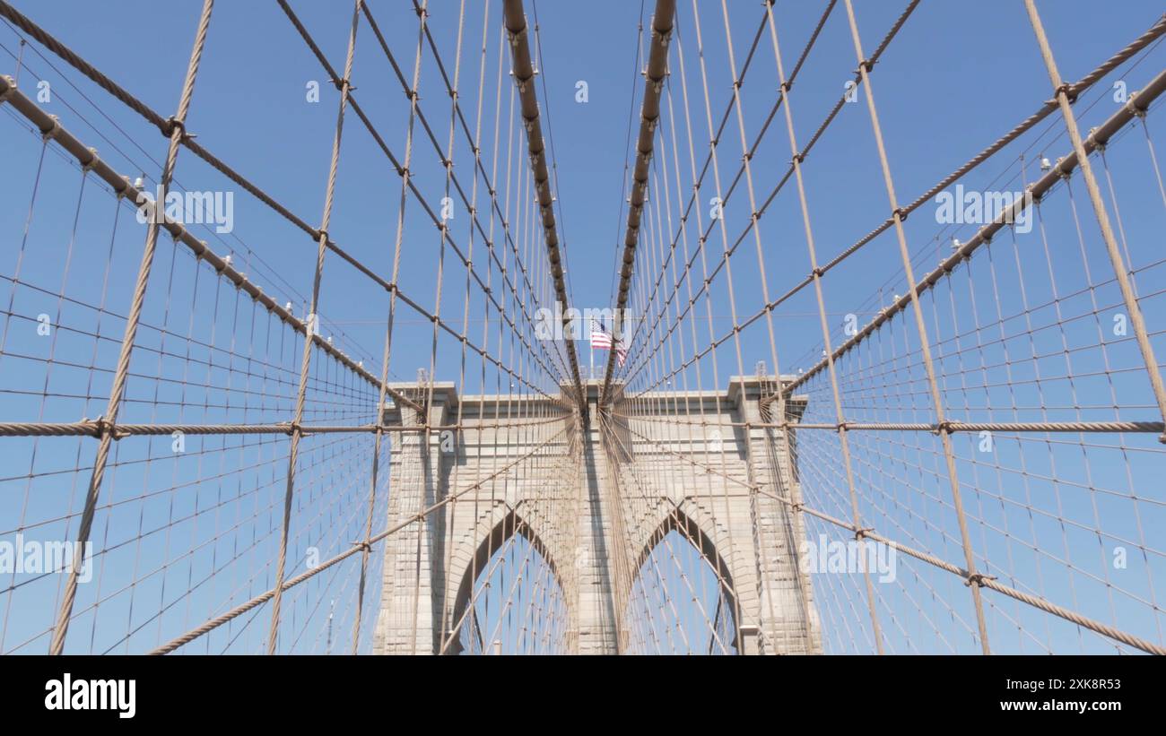 Brooklyn Bridge to Manhattan downtown, cables and blue sky. New York ...