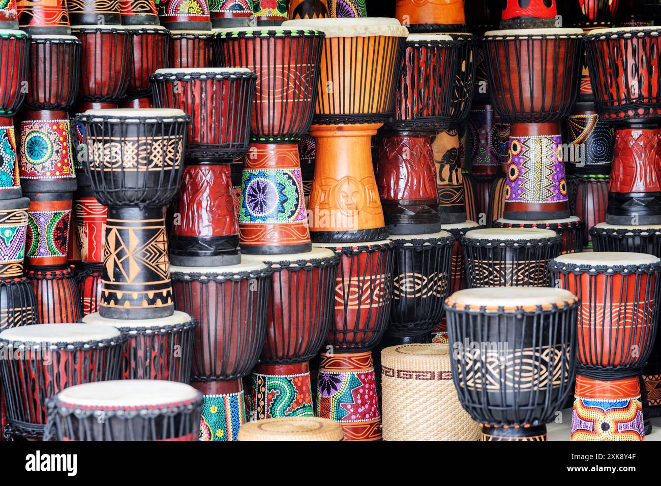 Rows of colorful wooden djembe drums at souvenir shop Stock Photo - Alamy