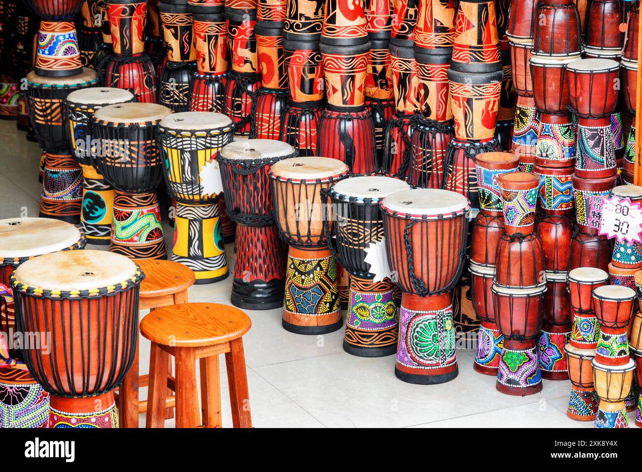 Wide range of colorful djembe drums at souvenir shop Stock Photo - Alamy