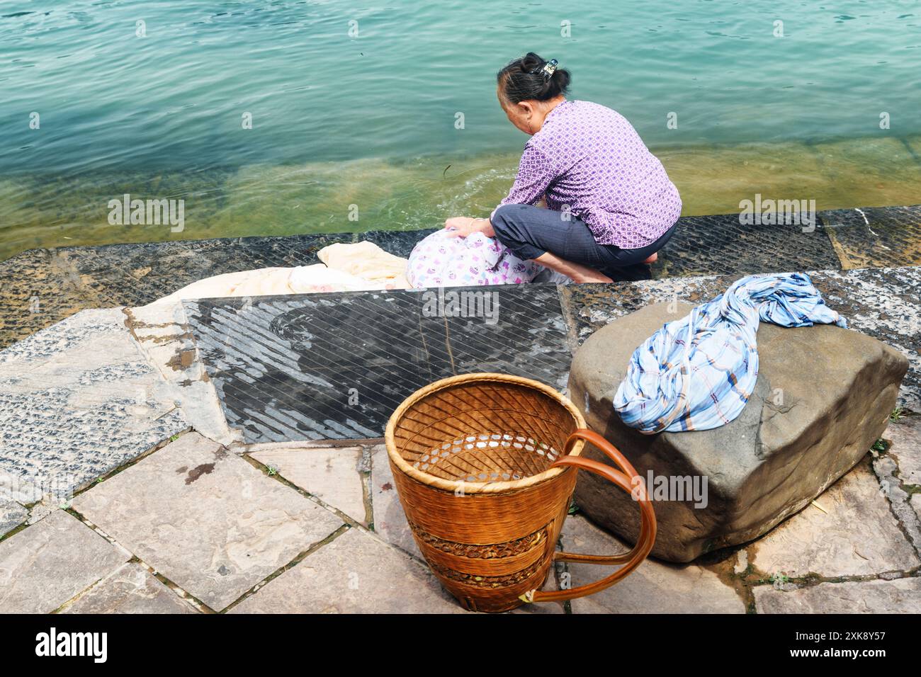 Old Chinese woman washing clothes in the Tuojiang River Stock Photo - Alamy