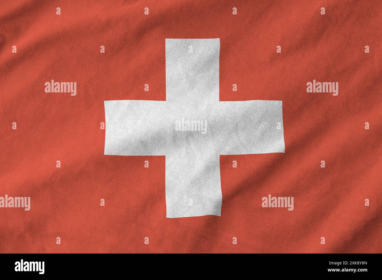 Switzerland flag depicted on folded wavy fabric of old cloth close up ...