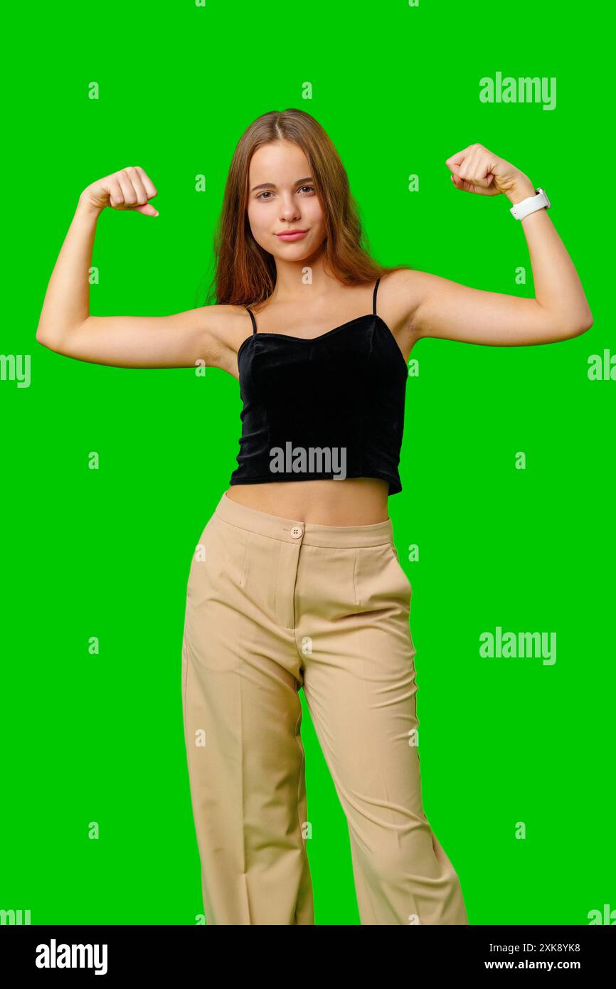 Young Woman Celebrating Success With Raised Fists Against Green Screen ...
