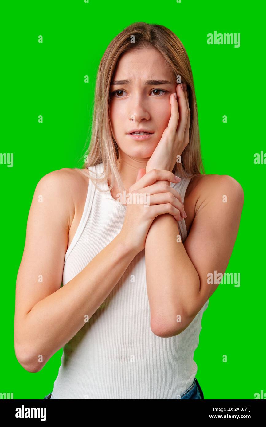 Woman Holding Her Face in Pain Against Green Screen Stock Photo - Alamy
