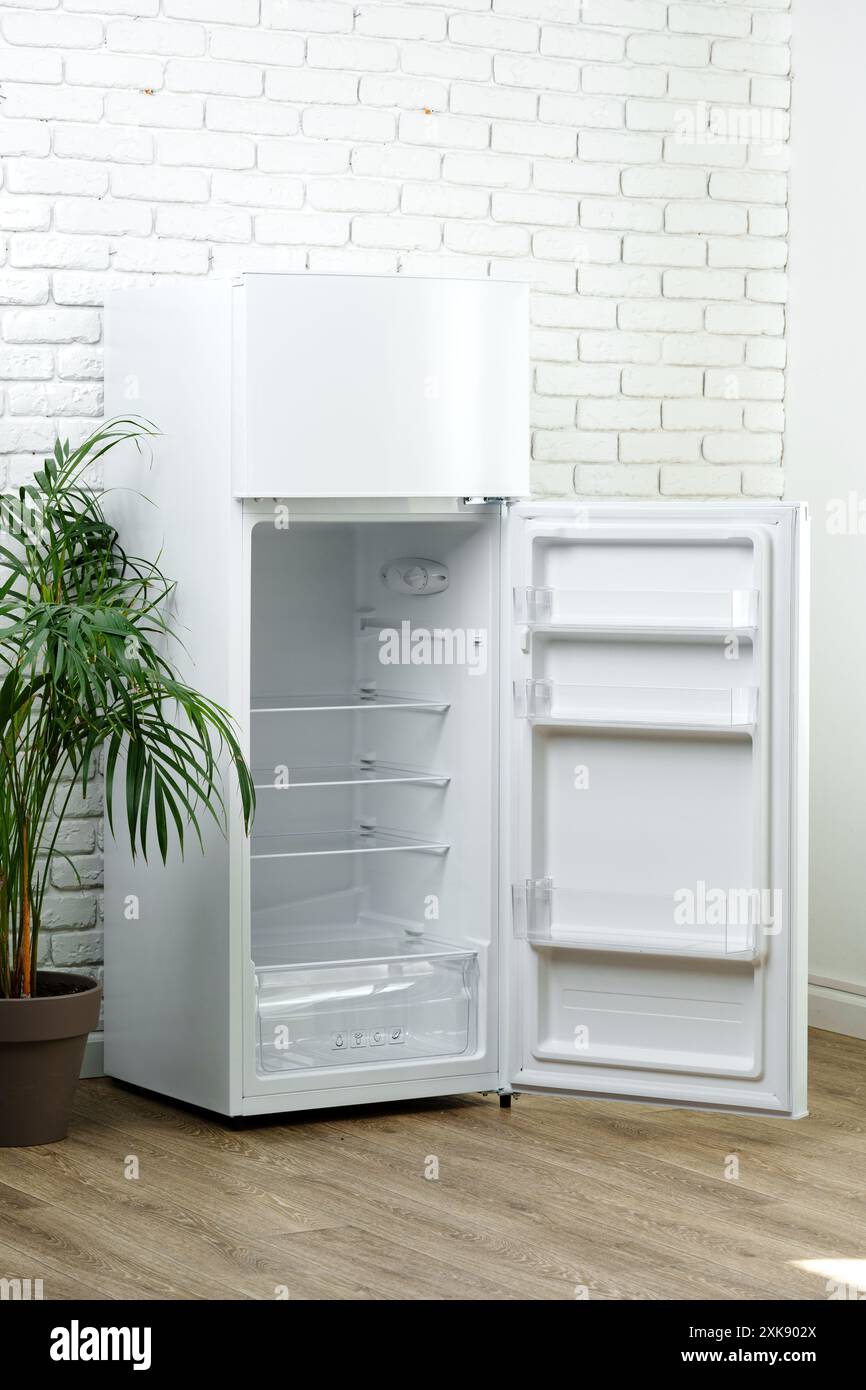 White Refrigerator Open Against Brick Wall Stock Photo - Alamy