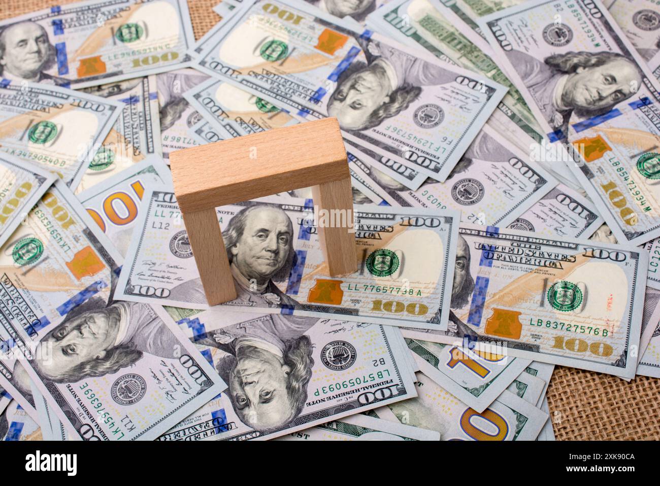 Wooden building blocks placed on spread US dollar Banknotes Stock Photo ...