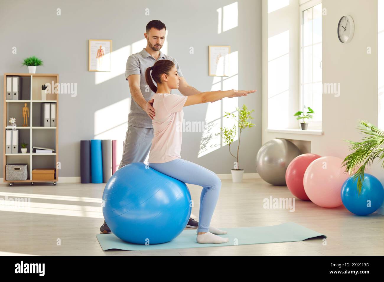 Rehabilitation spine exercise on fitness ball, spinal therapy by male ...