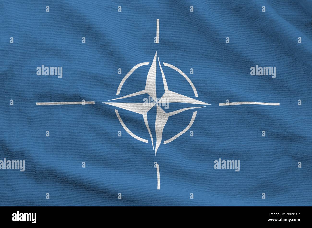 Nato flag depicted on folded wavy fabric of old cloth close up Stock ...