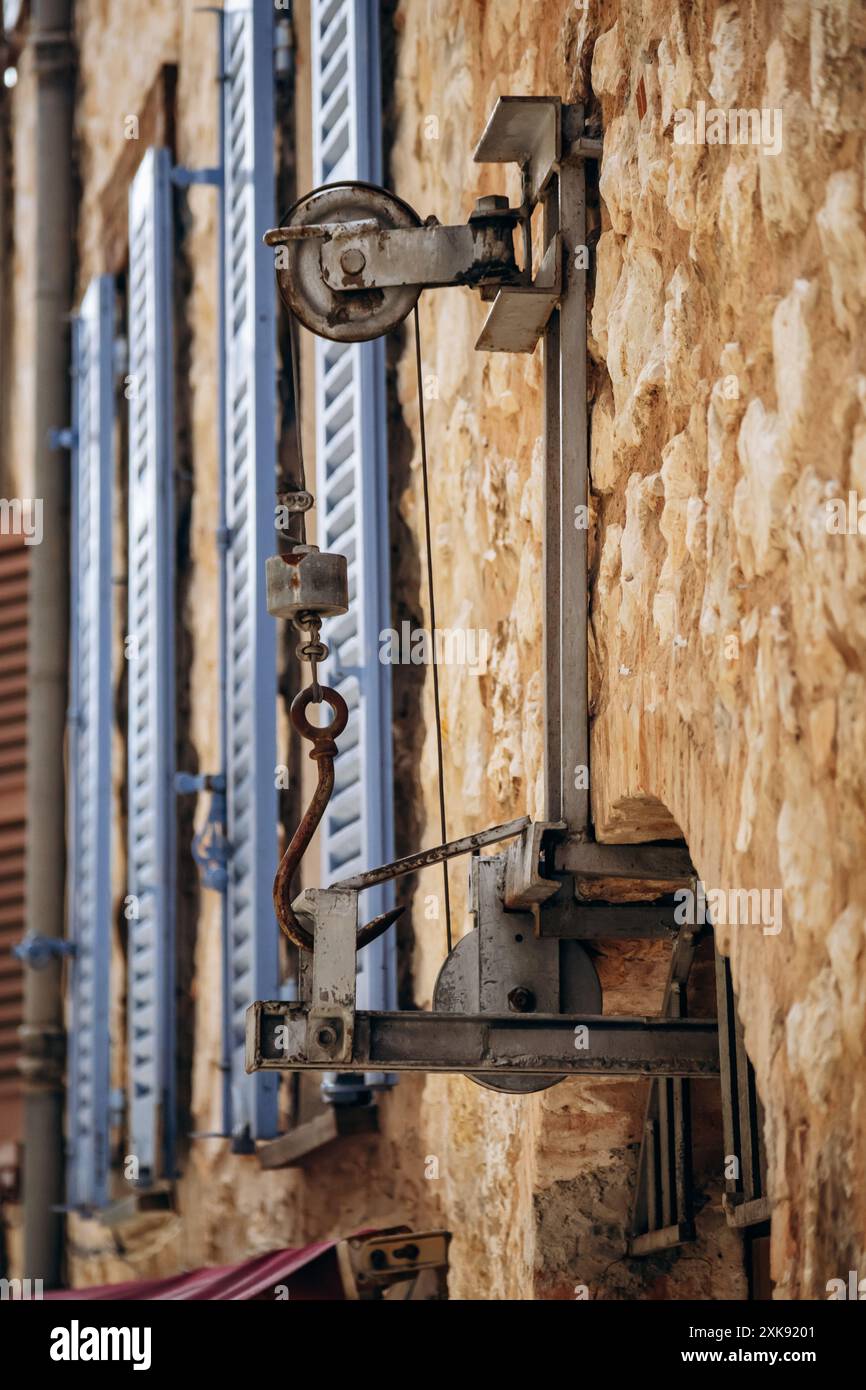 Lifting mechanism on the facade of an old house in Tourettes-sur-Loup ...