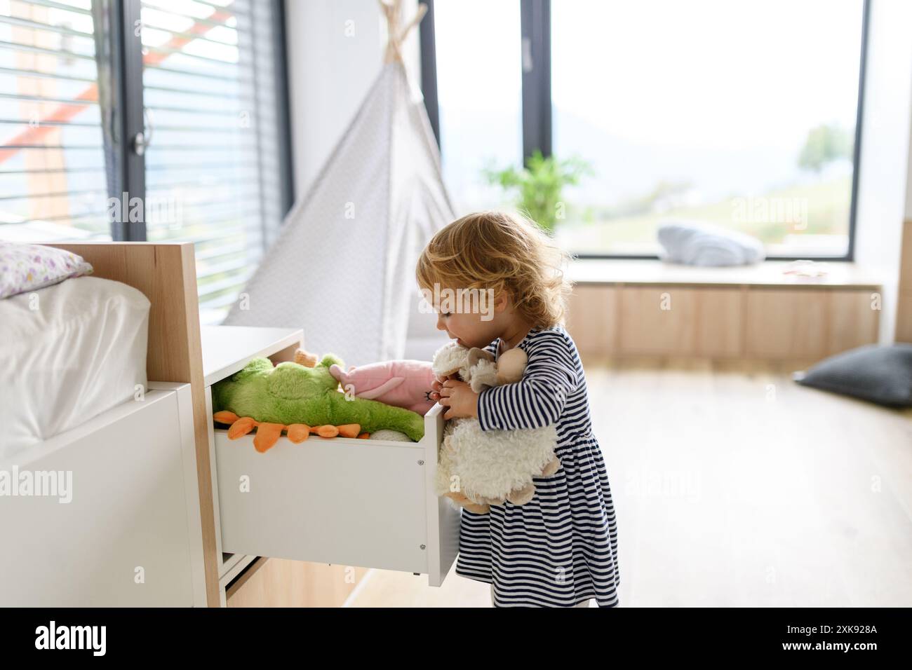 Cute small girl searching for plush toy in her room Stock Photo - Alamy