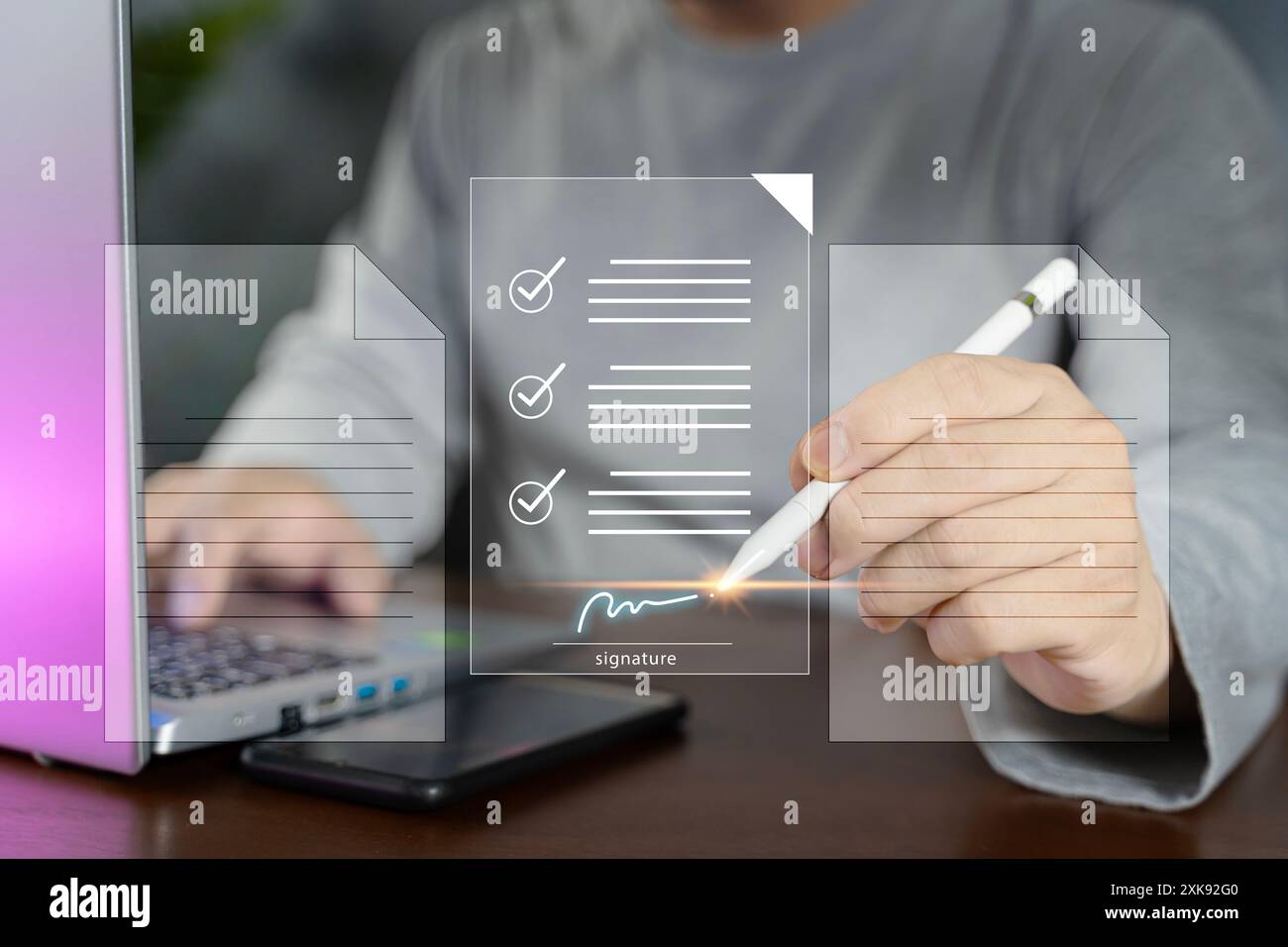 Electronic signature and paperless office concept. A businessman uses a ...