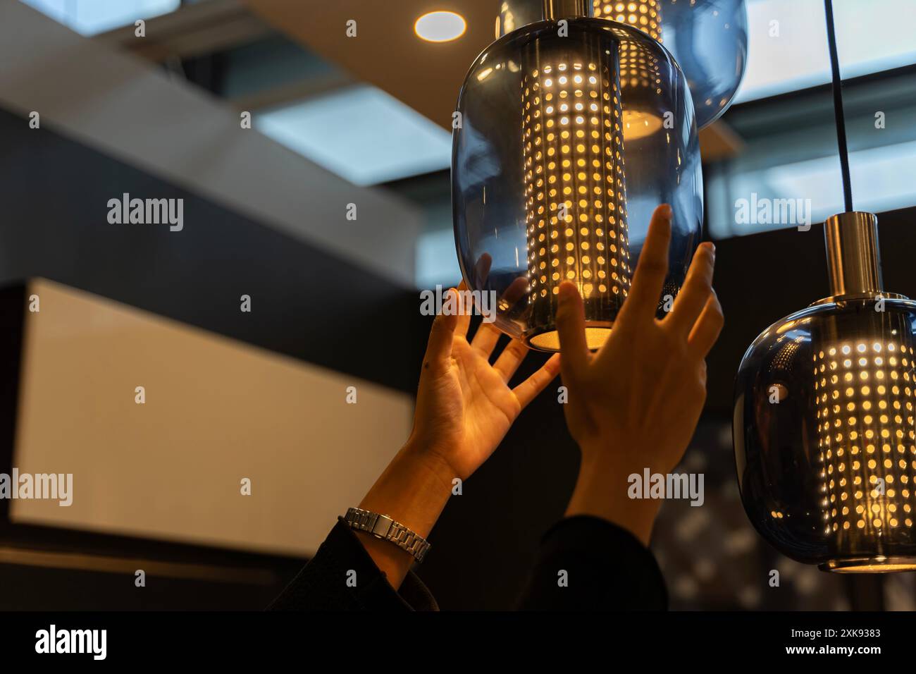 Woman changing light bulbs in the kitchen. Electric LED bulbs change ...