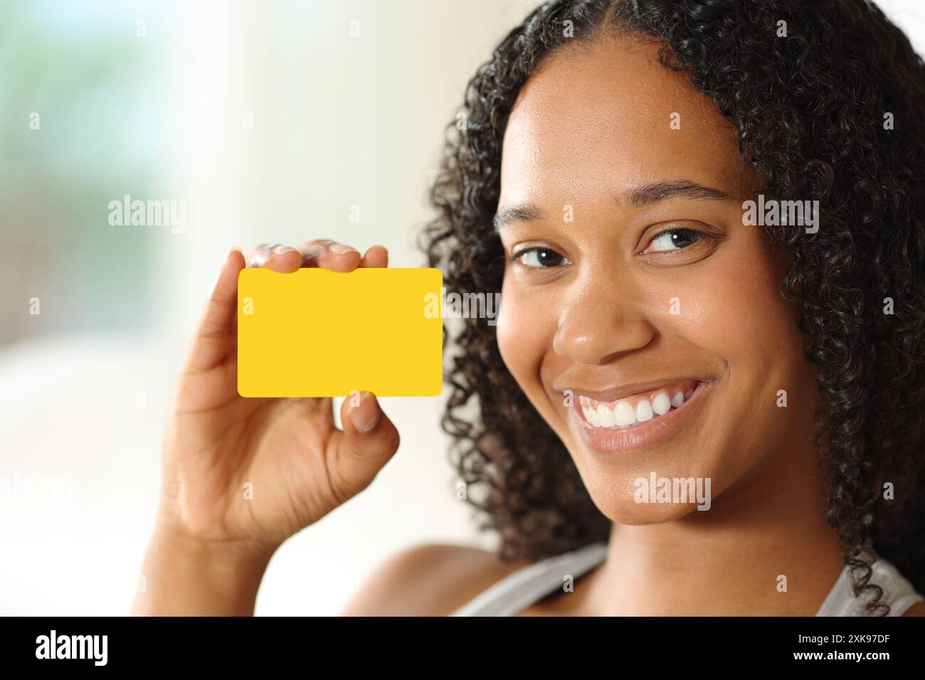 Portrait of a happy black woman showing blank card at home Stock Photo ...