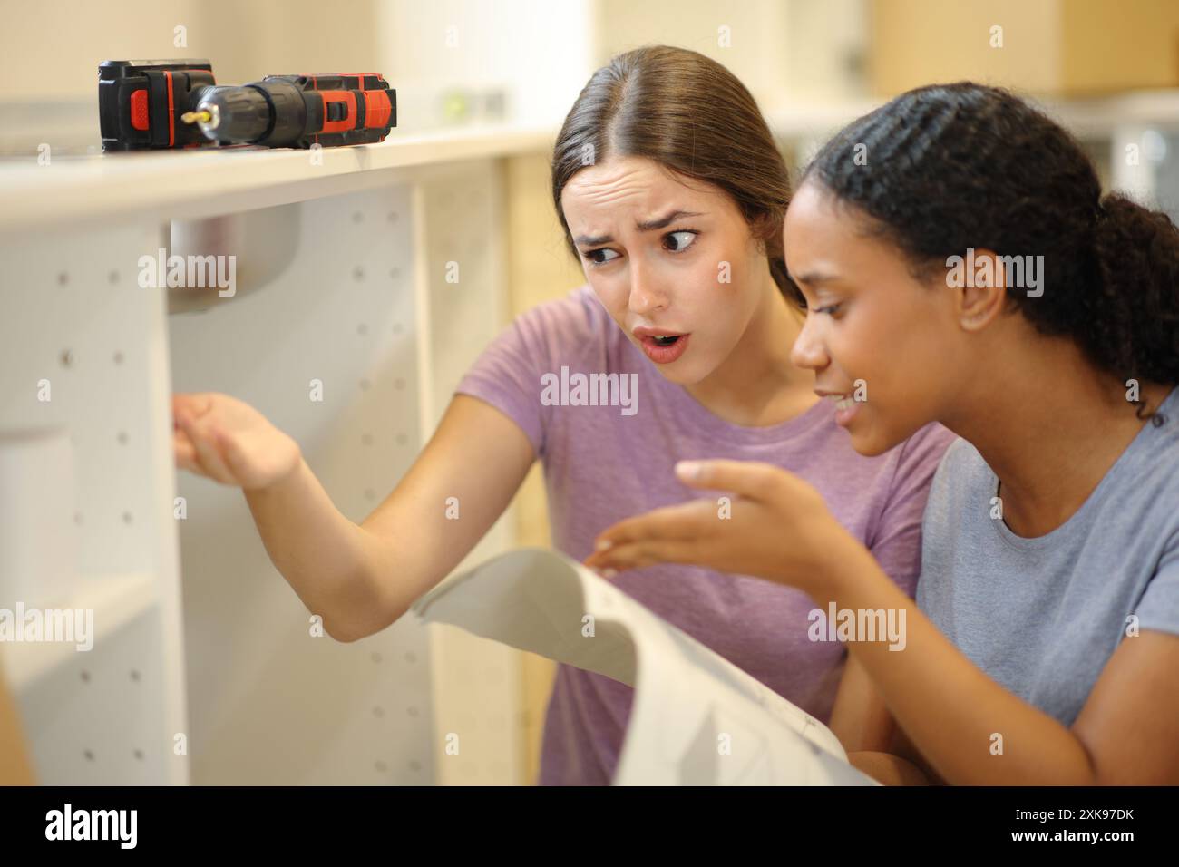 Two angry roommates arguing about furniture installation reforming ...