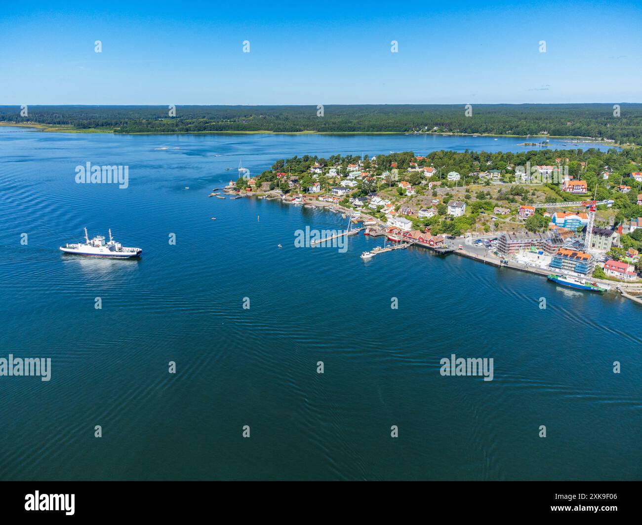 Car ferry approaching the dock, swedish archipelago, summer, blue sky ...
