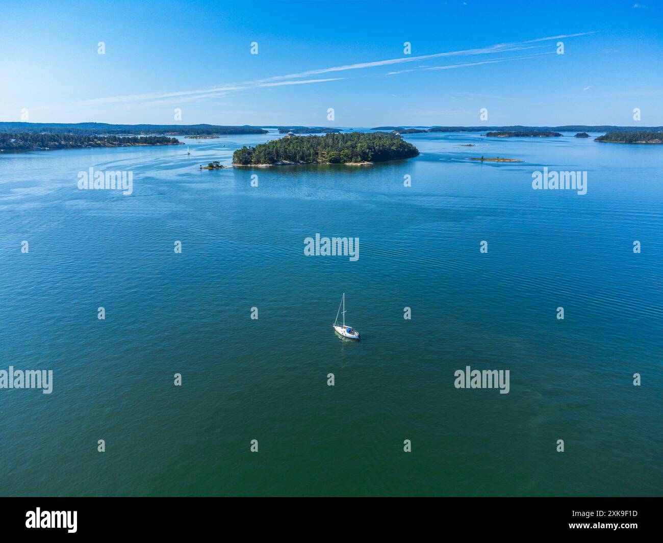 A sailboat in the Stockholm archipelago with its many islands, Kayaks ...