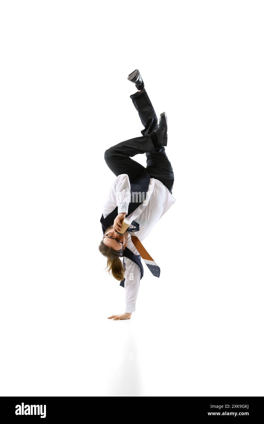 In suit and tie, breakdancer executes stunning handstand, and drinks ...