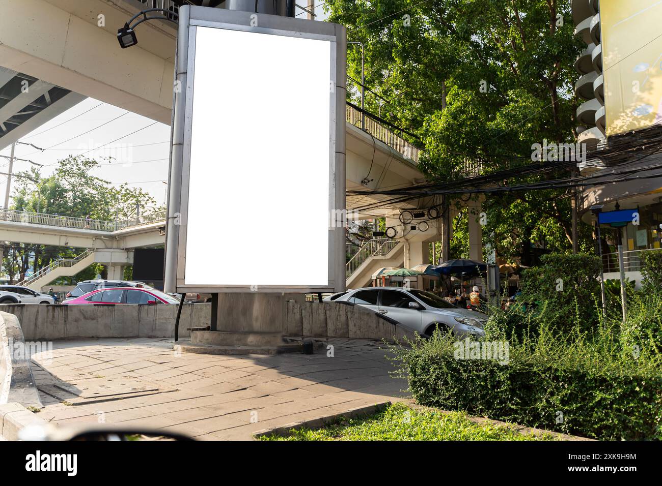 Mock up of light box in a city near traffic jam. Blank banner at dusk ...