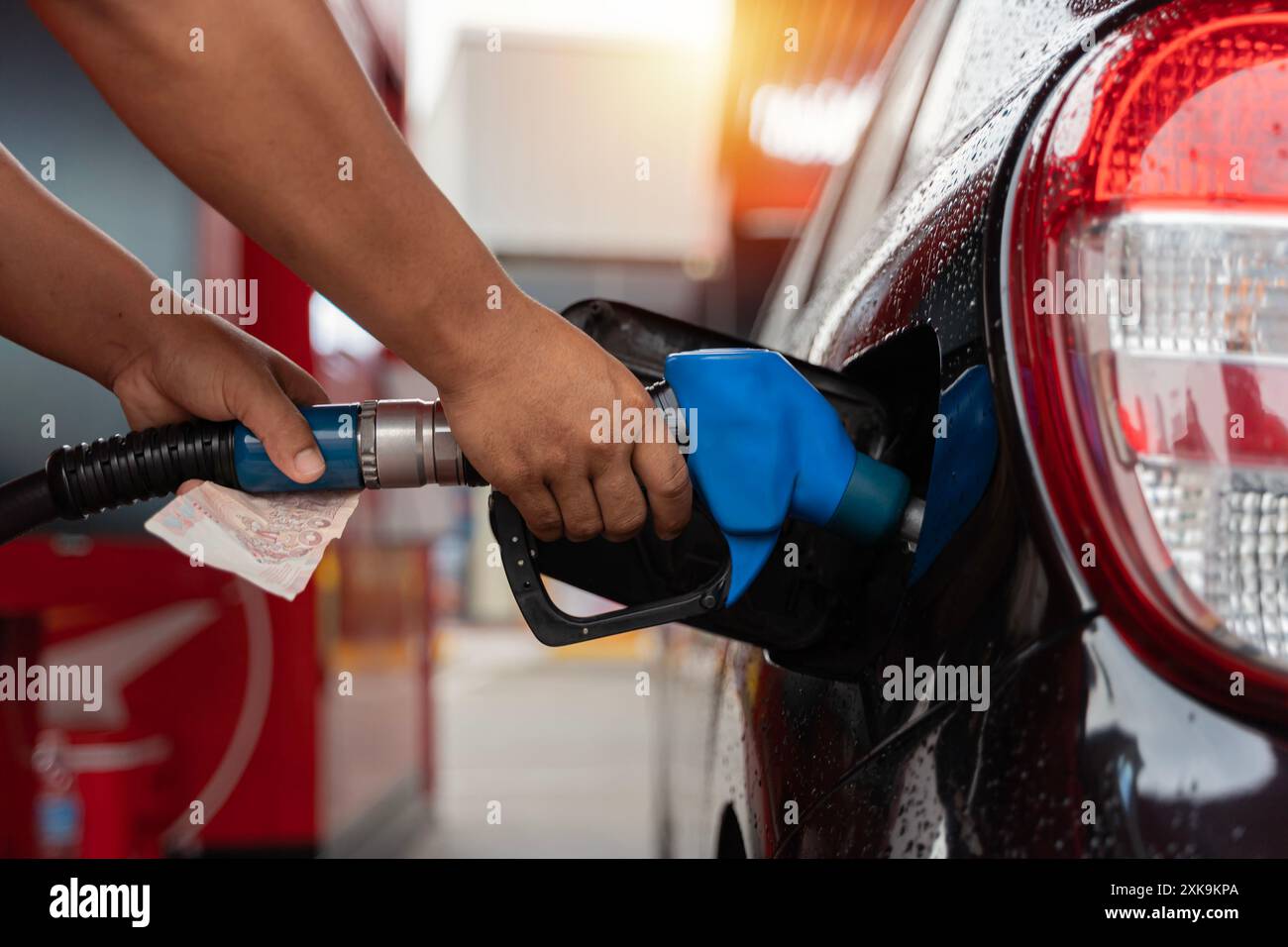 Refueling the car at a gas station fuel pump. Man driver hand refilling ...